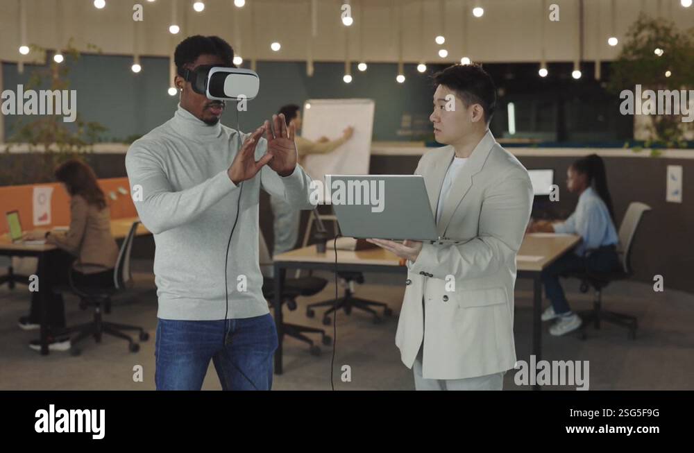 It company. African american man testing a VR simulator headset and ...