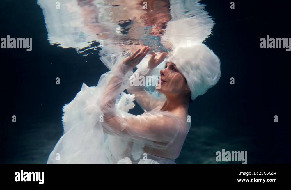 underwater fantasy with fabulous fairy lady in white gown, woman is ...