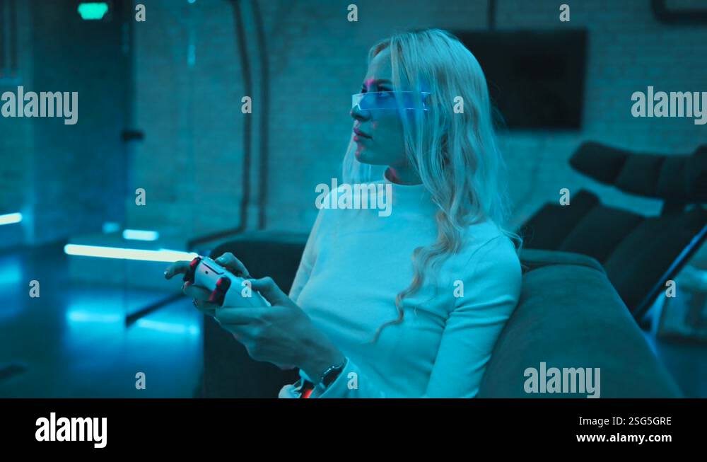 Young female gamer playing console in neon room Stock Video Footage - Alamy