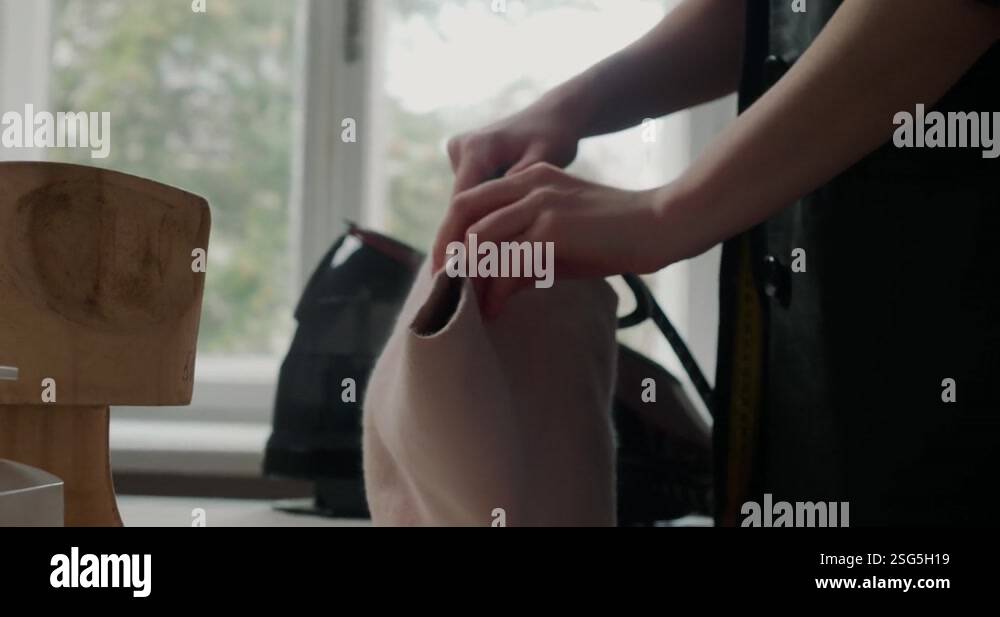Milliner uses iron to steam felt body at table in workshop Stock Video ...