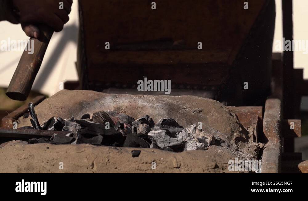 Traditional Forge Coal Furnace Being Pumped With Air By A Blacksmith To ...