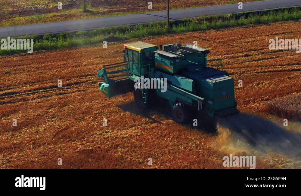 Combine Harvesting Wheat Crops At The Farm In Lithuania. aerial Stock ...
