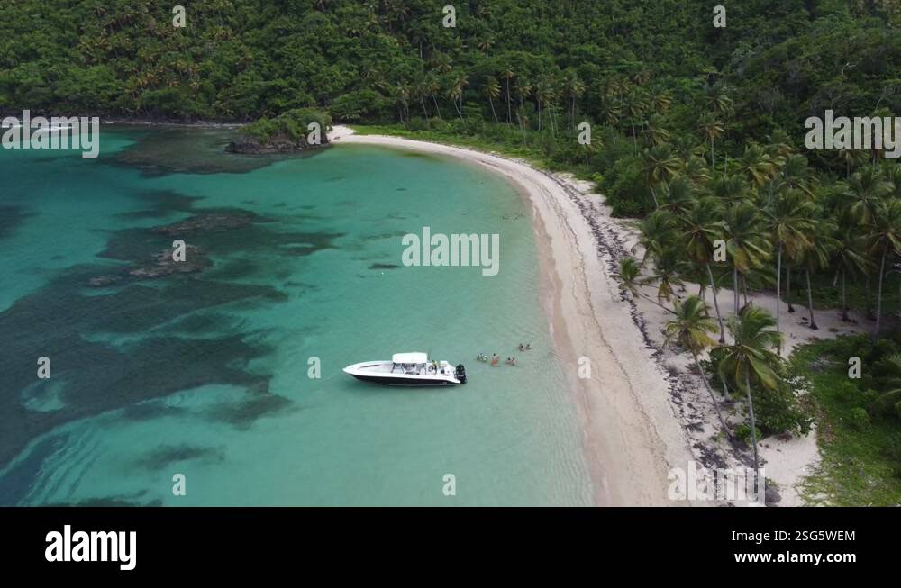 Flyover yacht boat anchored at Playa El Ermitano beach over pristine ...