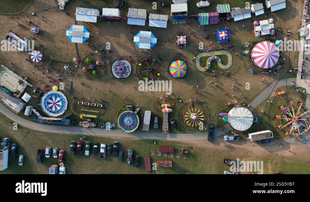 Colorful carnival rides. Top down aerial of fair festival at ...