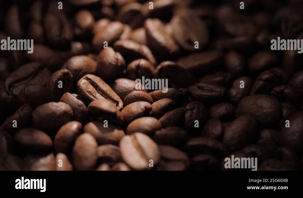 Coffee beans. Close-up view of camera pans up and showing roasted ...