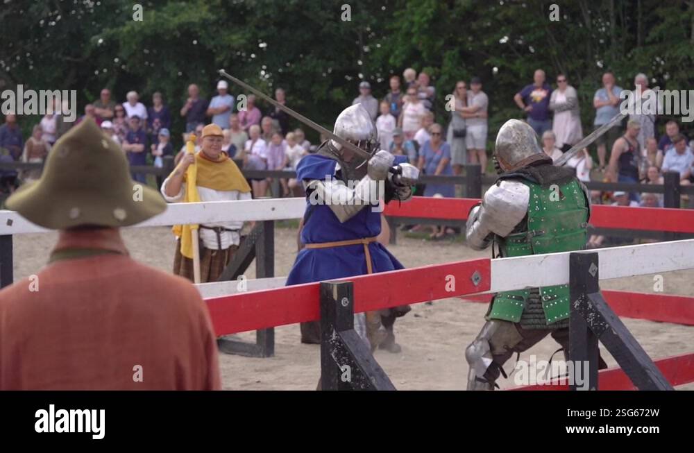 People Watching Armored Fighters Wielding Their Sword During A Fight ...