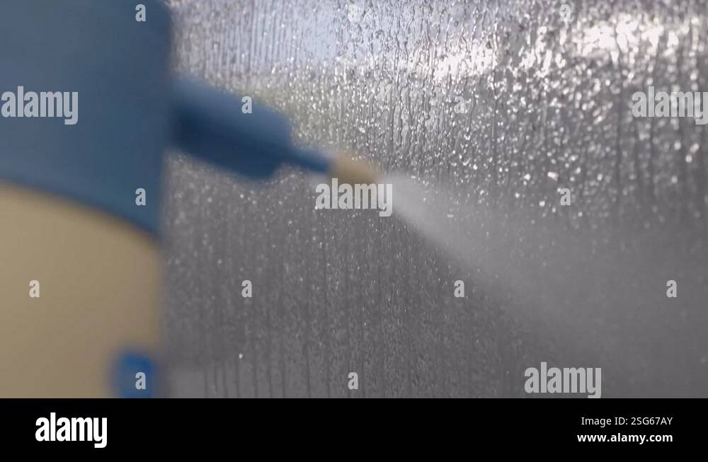Spraying a Coating of Wet Liquid on the Body of a Car, Close up Stock ...