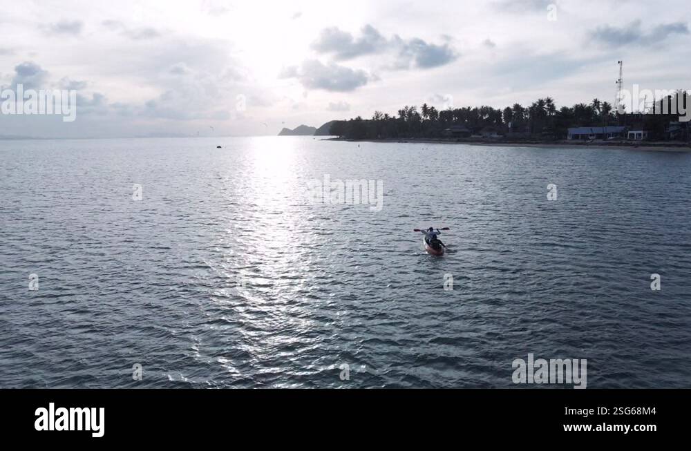 Rising aerial parallax of two people using kayak by coast of Thailand ...