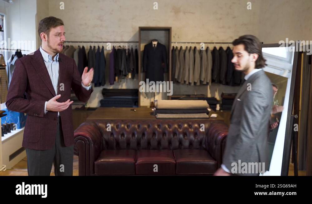 Fashion boutique expert describing suit wearing rules on customer Stock ...