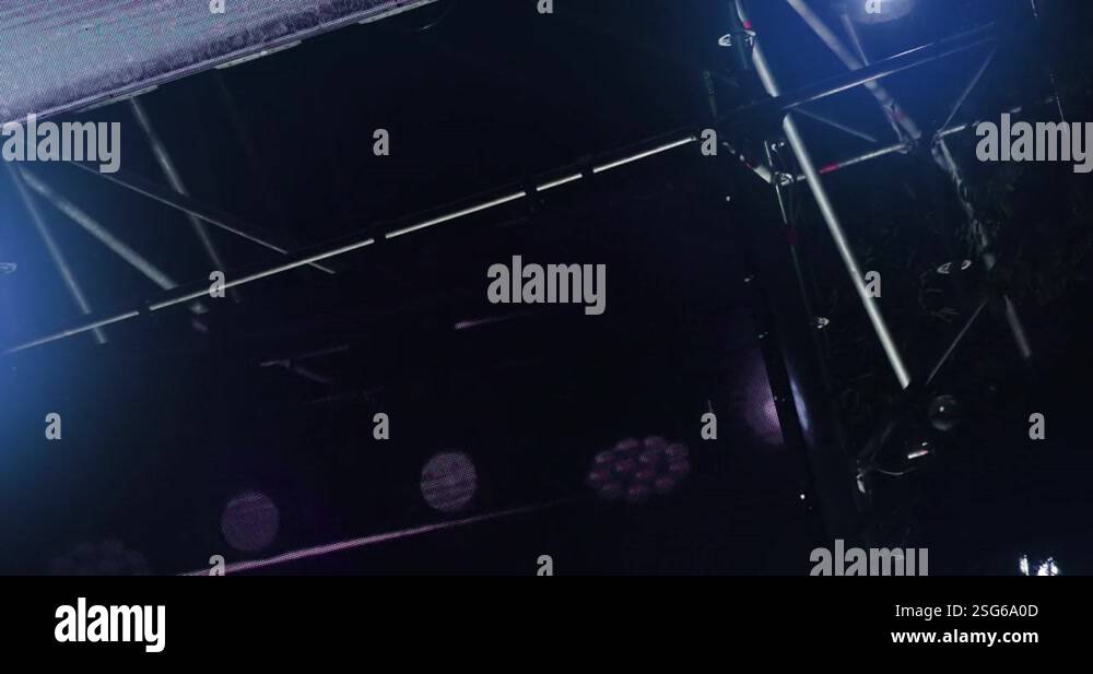 flashing and rotating light beams from stage lights on a construction ...