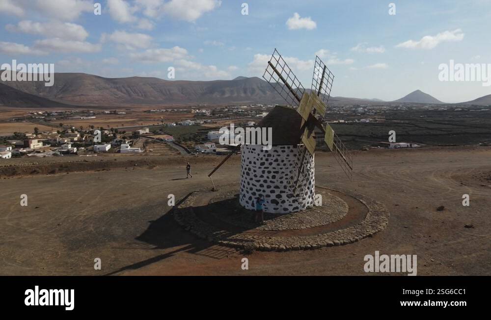 Aerial shot in orbit over an old grain mill in Fuerteventura ...