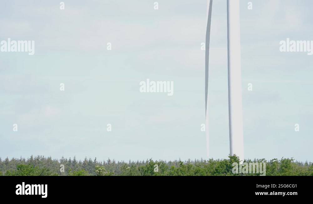 Huge Wind Turbine Blade Rotating against a Light Blue Sky Background ...