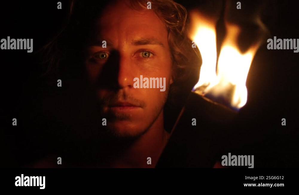 Man opens his eyes in the dark and watches with scary evil look Stock ...