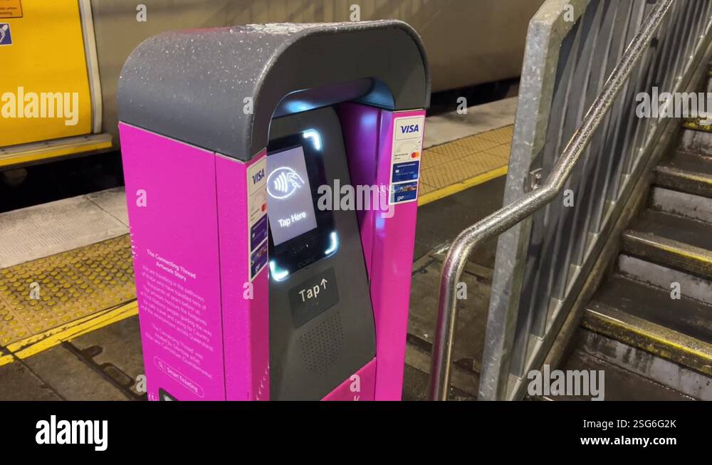 Traveller tapping go card on the ticketing machine to touch on and off ...