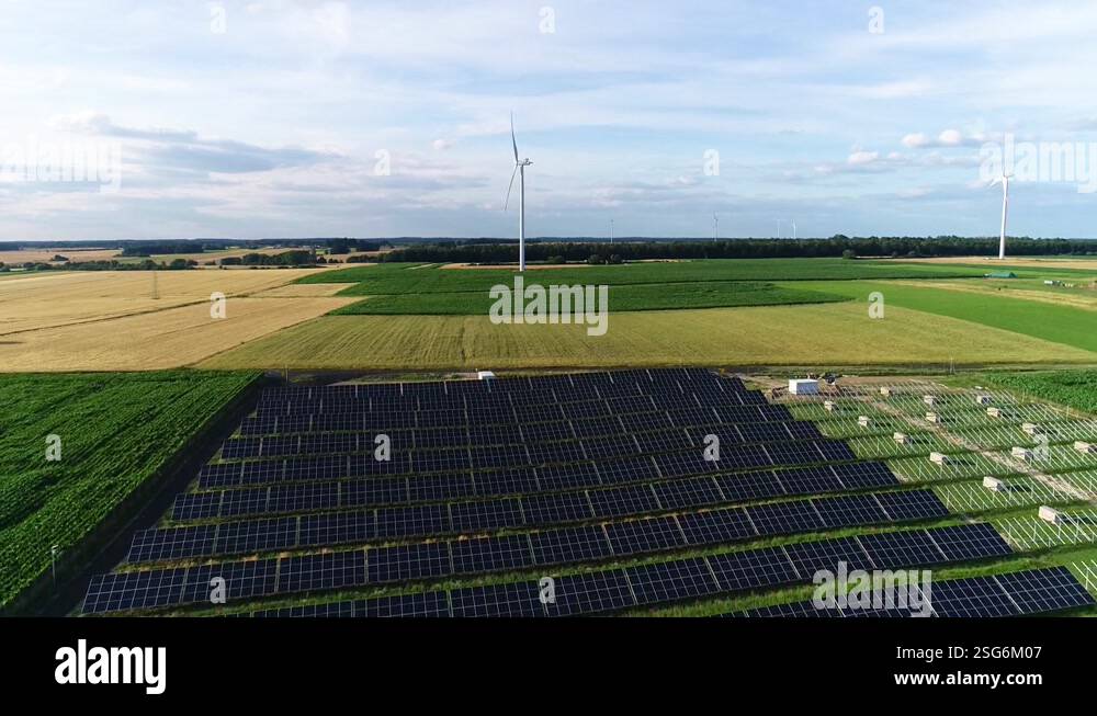 Building Solar Farm. Aerial view of Photovoltaic energy panel and wind ...