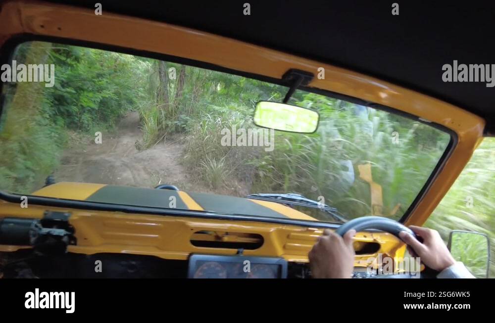 POV Driving up a bumpy road in a yellow Jeep in Bali, Indonesia Stock ...