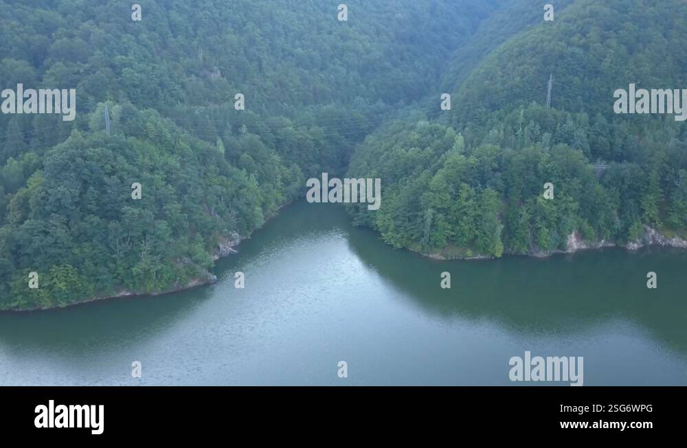 Calm and quiet morning on Lake Tarnita as the sun rises. Peaceful cove ...