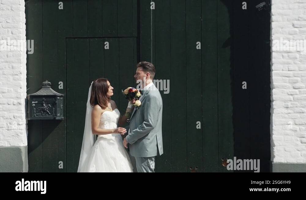 Romantic scene outside a green gate of a wedding couple in Thorn, The ...