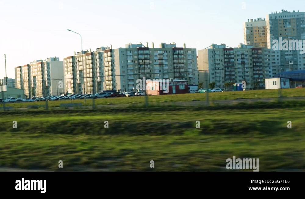 View from the window of a moving car on multi-storey residential ...