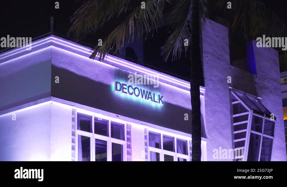 Art deco district at night with neon lights sign of Deco Walk Hotel ...