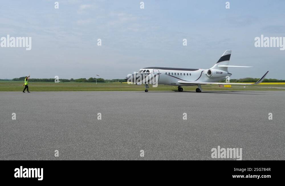 Aircraft Ground Crew Marshalling A Dassault Falcon 2000LX Jet Plane ...