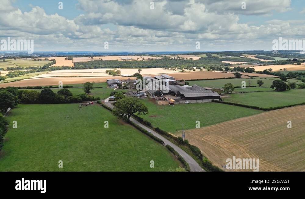 Aerial footage of a modern day farm and out buildings in a rural ...