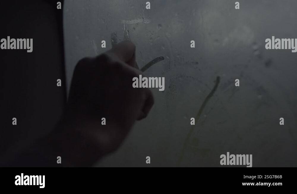Writing help with hand on a foggy window in a car Stock Video Footage ...