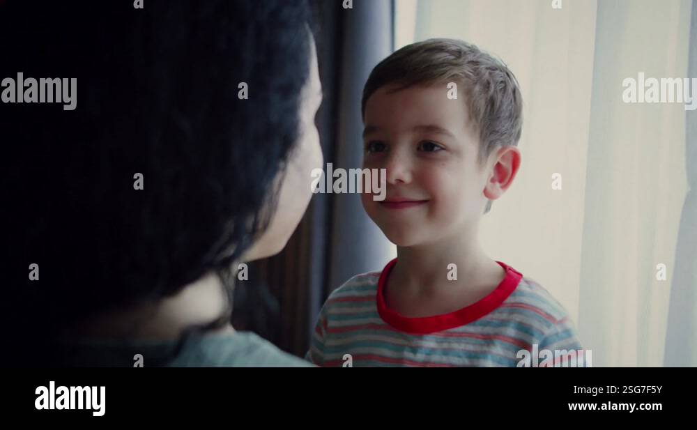 Portrait of mother and son, mother strokes the nose of her smiling son with her Stock Video ...
