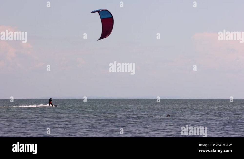 Kitesurfing Kiteboarding On The Waves In The Sea Performing Kitesurfing ...