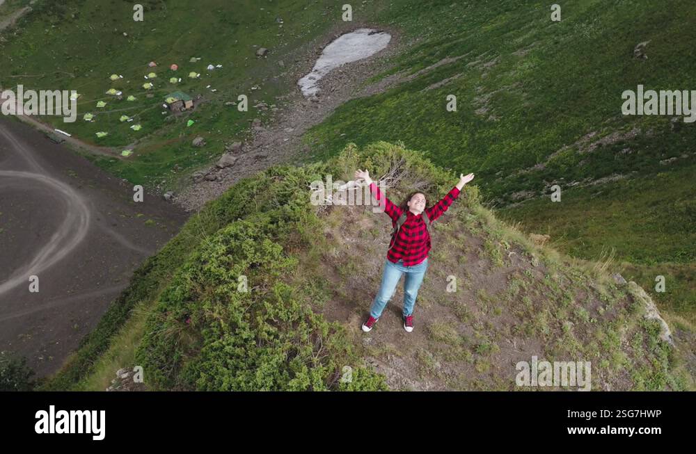 Woman enjoys view on mountain top over valley Stock Video Footage - Alamy