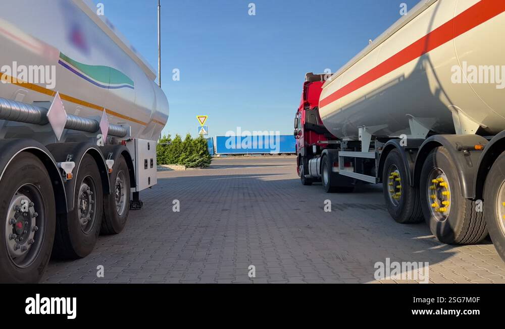 Gasoline trucks stand in the parking lot of the oil depot, waiting to ...