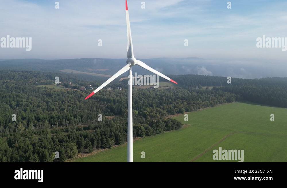 The drone camera slowly approaches the rotating propeller of a wind ...