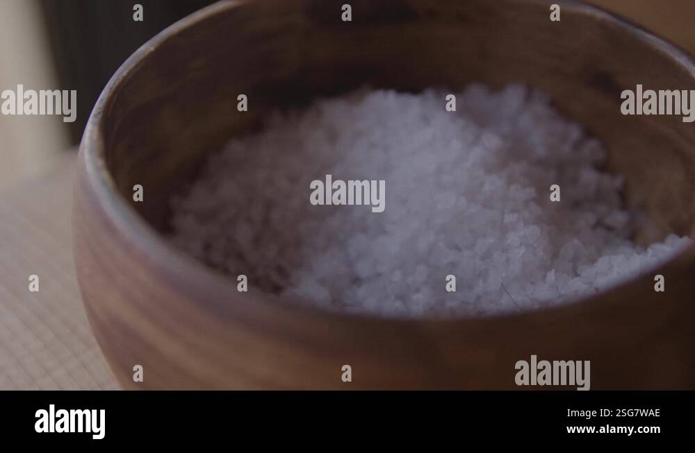 Old hand pouring sea salt into bowl. Indigenous gathering of salt Stock ...
