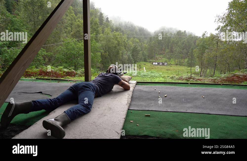 Person with hunting rifle shooting at targets on shooting range - Shots ...