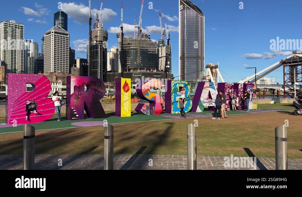 Sunny day at river bank, tourists at iconic landmark, colorful block ...