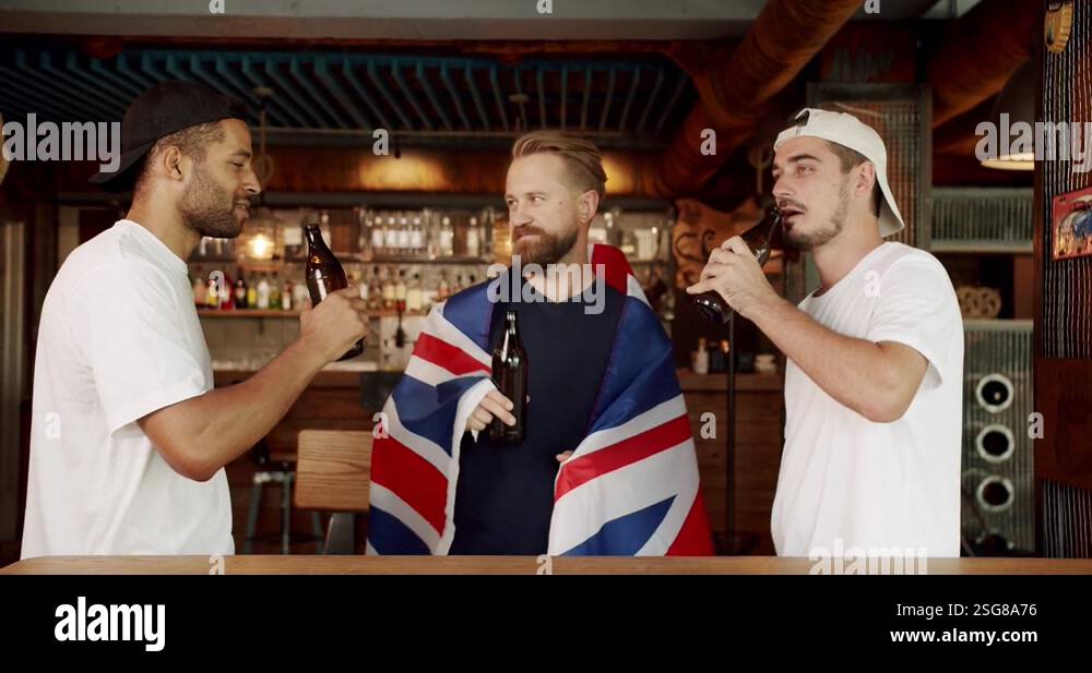 Soccer fans celebrating victory of team in sports bar. Friends in a Pub ...