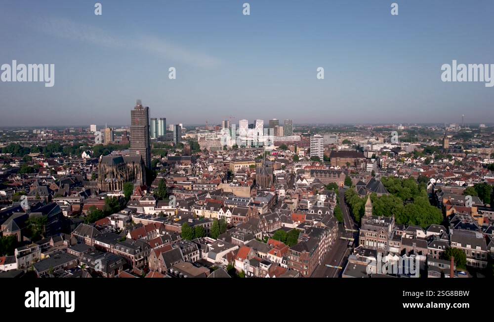 Aerial descend showing De Dom medieval cathedral tower in scaffolding ...