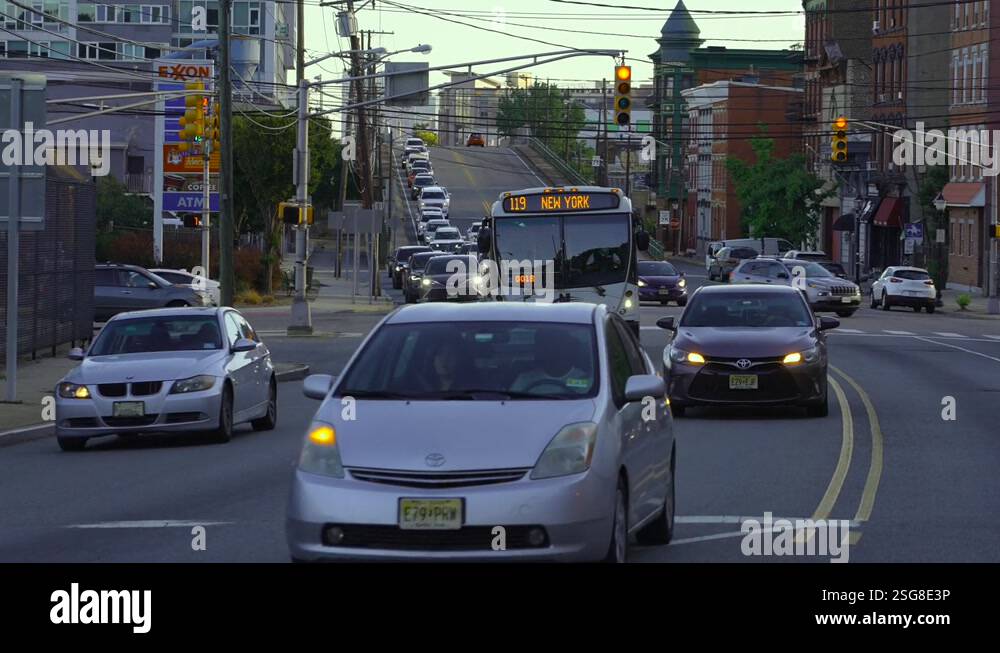Street level view of oncoming traffic. NJ Transit public bus and cars ...