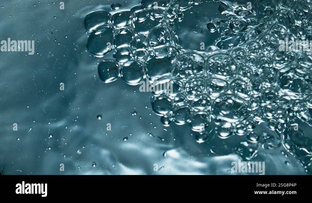 Sparkling aqua bubbling inside container closeup. Soda fizzy drink ...
