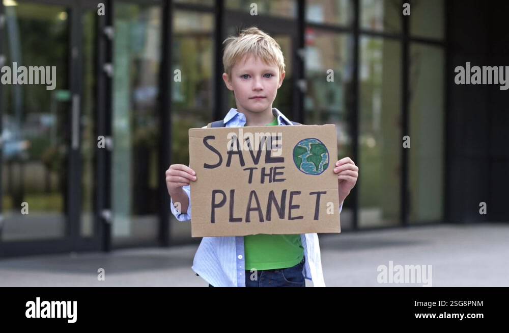Boy is holding a SAVE THE PLANET poster. The younger generation stands ...
