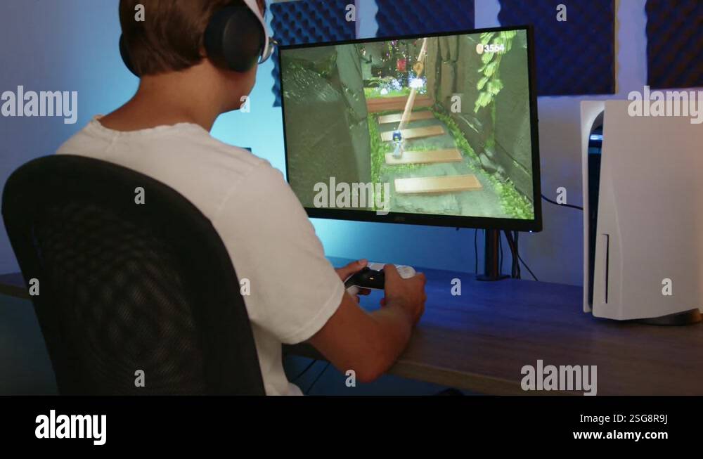 Boy gaming on a PlayStation 5 with a PS5 controller and headset in an ...