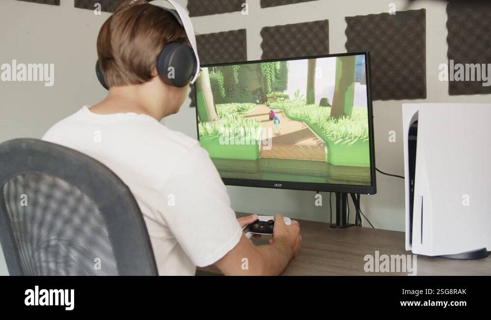Boy gaming on a PlayStation 5 with a PS5 controller and headset in the ...
