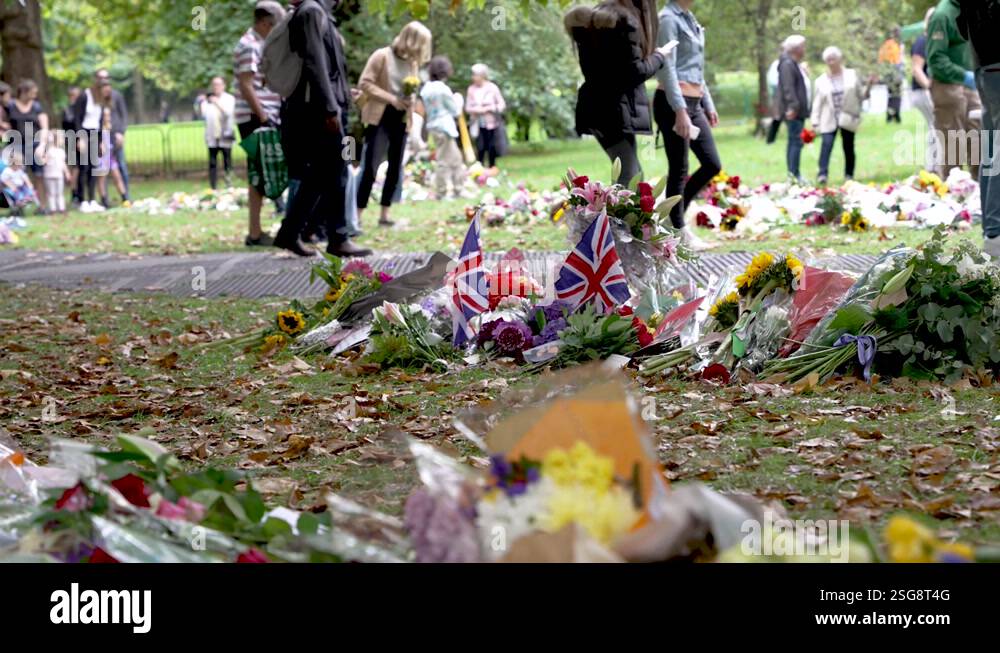 Small Union Jack Flags In The Ground Beside Floral Tributes For Death ...