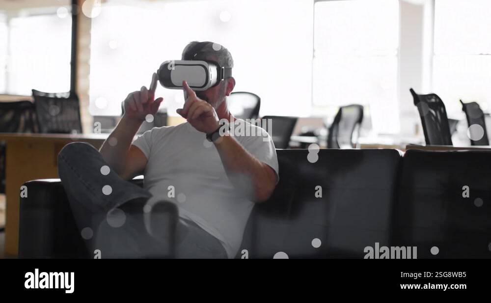 Animation of spots over caucasian businessman using vr headset in ...