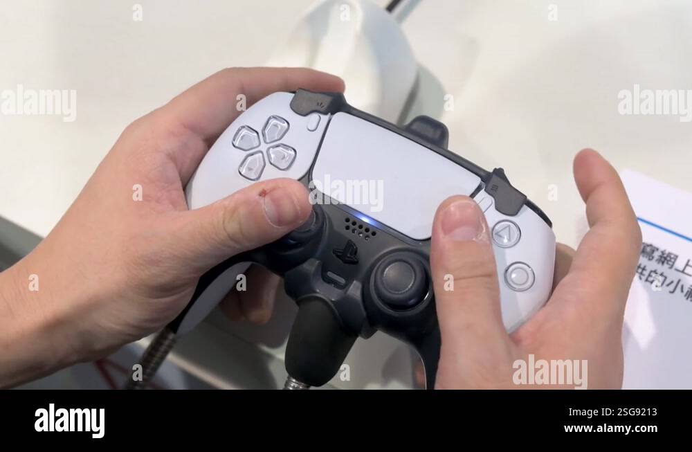 A gamer plays a videogame using a controller from the Japanese video ...