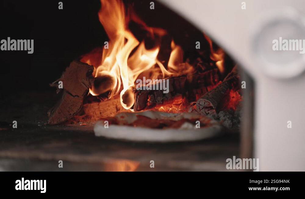 Rustical original pizza in oven fired by wood burning with beutiful ...