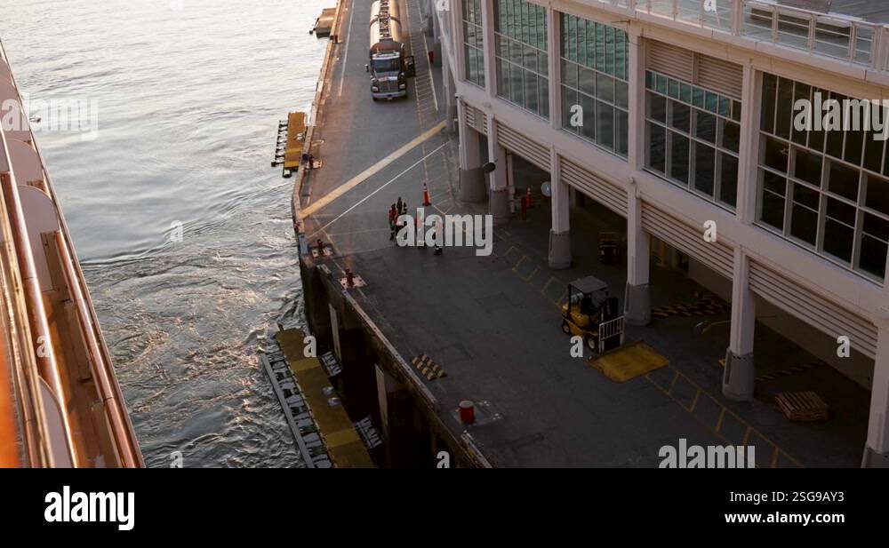 Dock workers standing by to receive mooring lines and tie off cruise ...