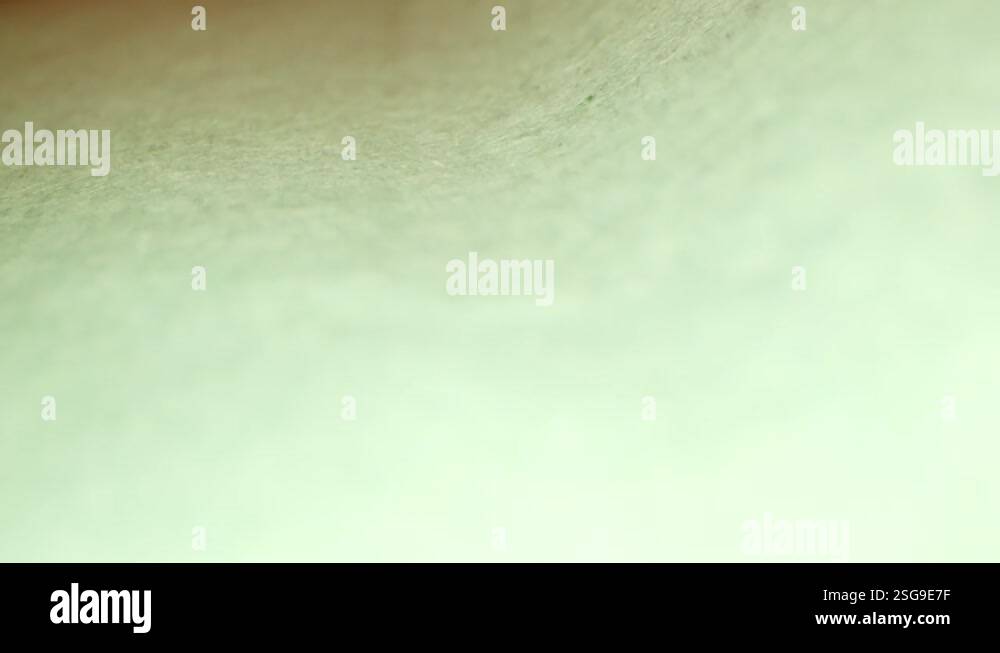 Pushing across the top of a lightly colored green tissue paper. Wide ...