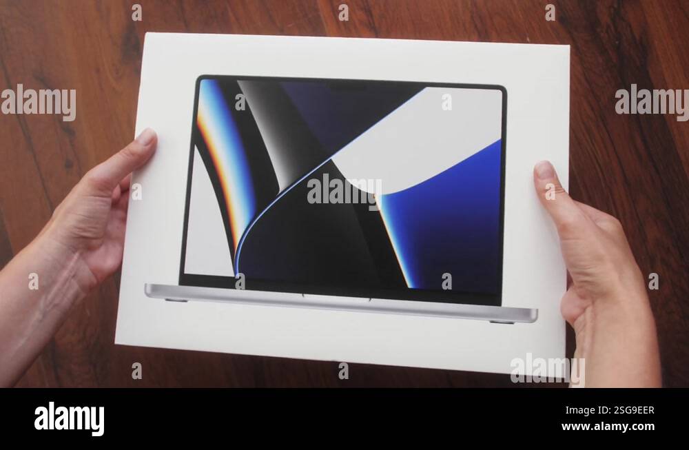 Female hands open a box with a new Apple MacBook Pro M1, September 2022 ...