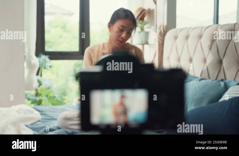 Asia girl influencer recording sharing morning routine in camera sit on ...